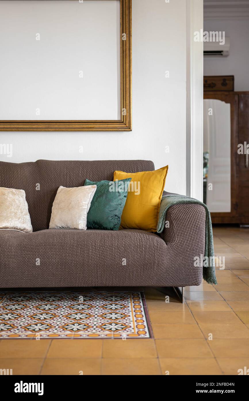 Fragment of a living room with a cozy interior sofa with pillows, floor ...
