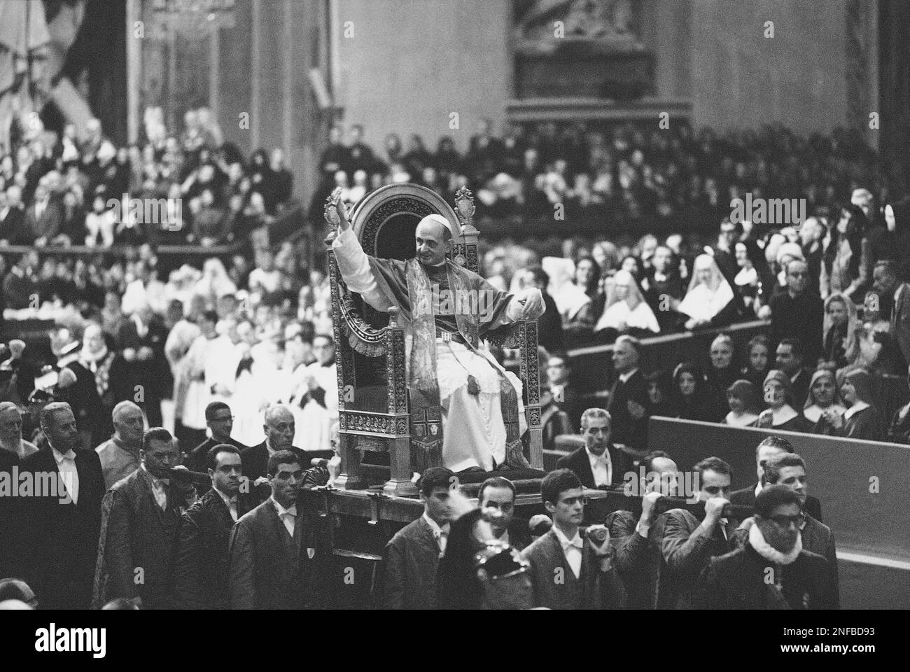 Pope Paul VI is carried on his portable chair as he responds to ...