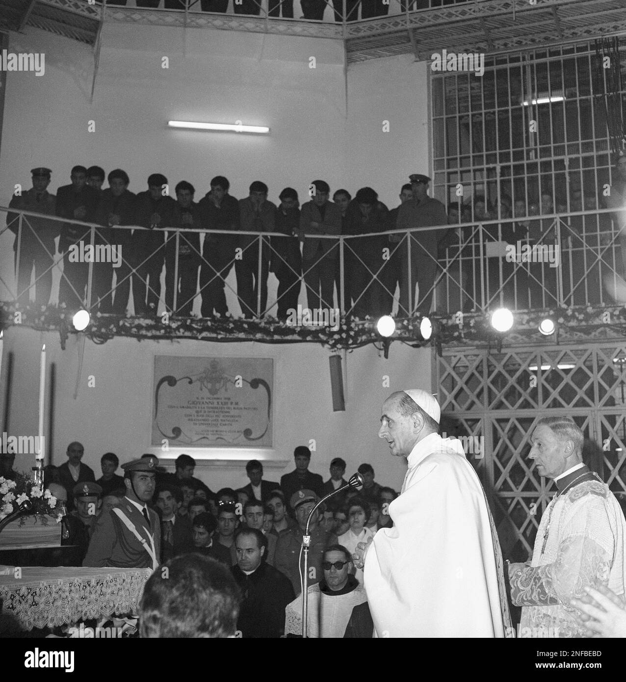 Pope Paul VI, standing in front of a temporary altar erected in one of ...
