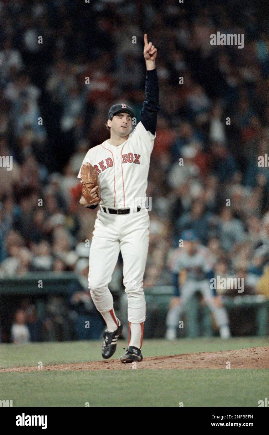 Boston Red Sox winning pitcher Bruce Hurst gives the number one sign as ...