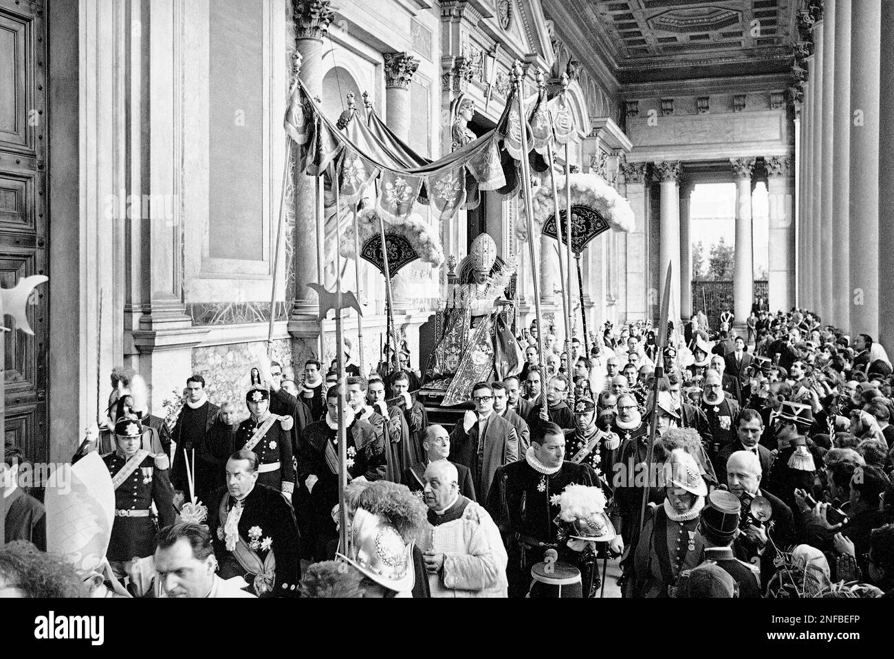 Pope Paul VI, wearing mitre, and holding blessed palms, is carried on ...