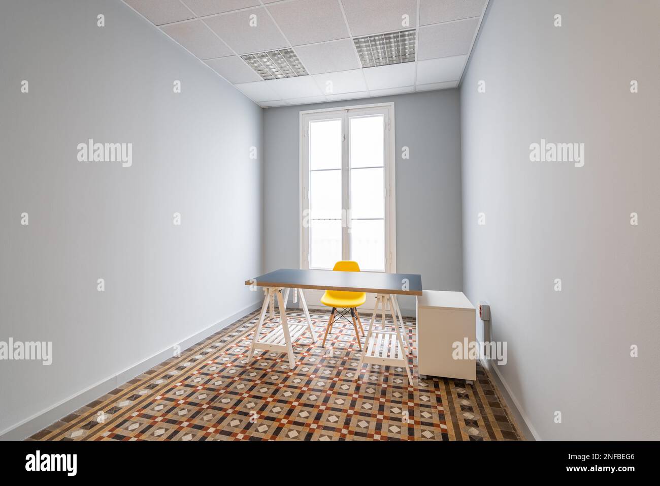 An empty room with gray smooth walls, doors leading to terrace. Floor ...