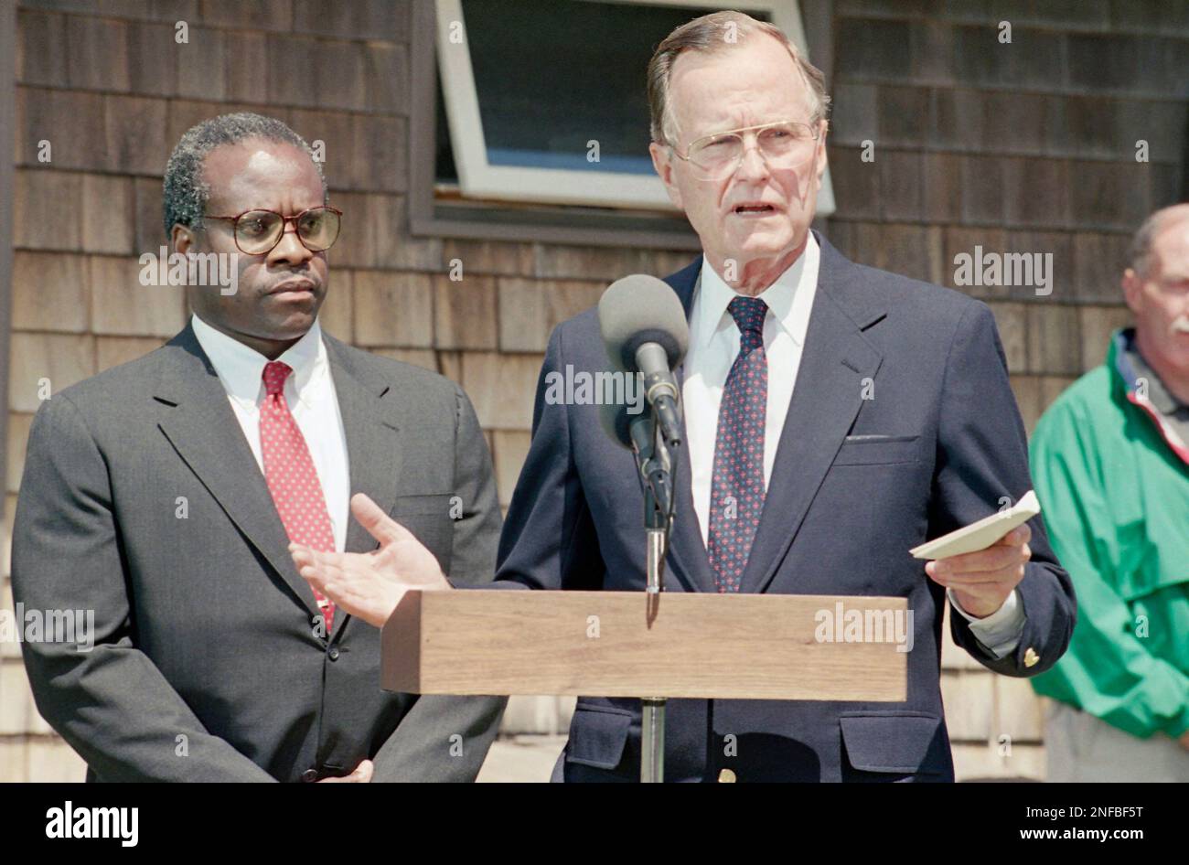 U.S. President George H. Bush introduces Judge Clarence Thomas, left ...