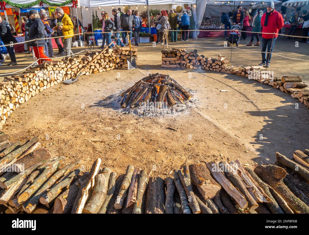 Start of big bonfire coming out smoke with wooden logs in a popular ...