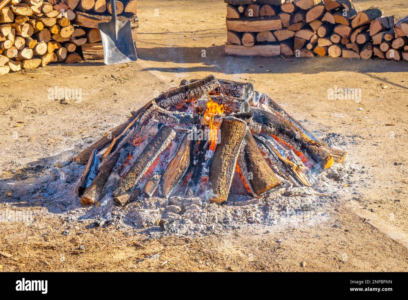 Top of a large circular bonfire packed with firewood on the sides that ...
