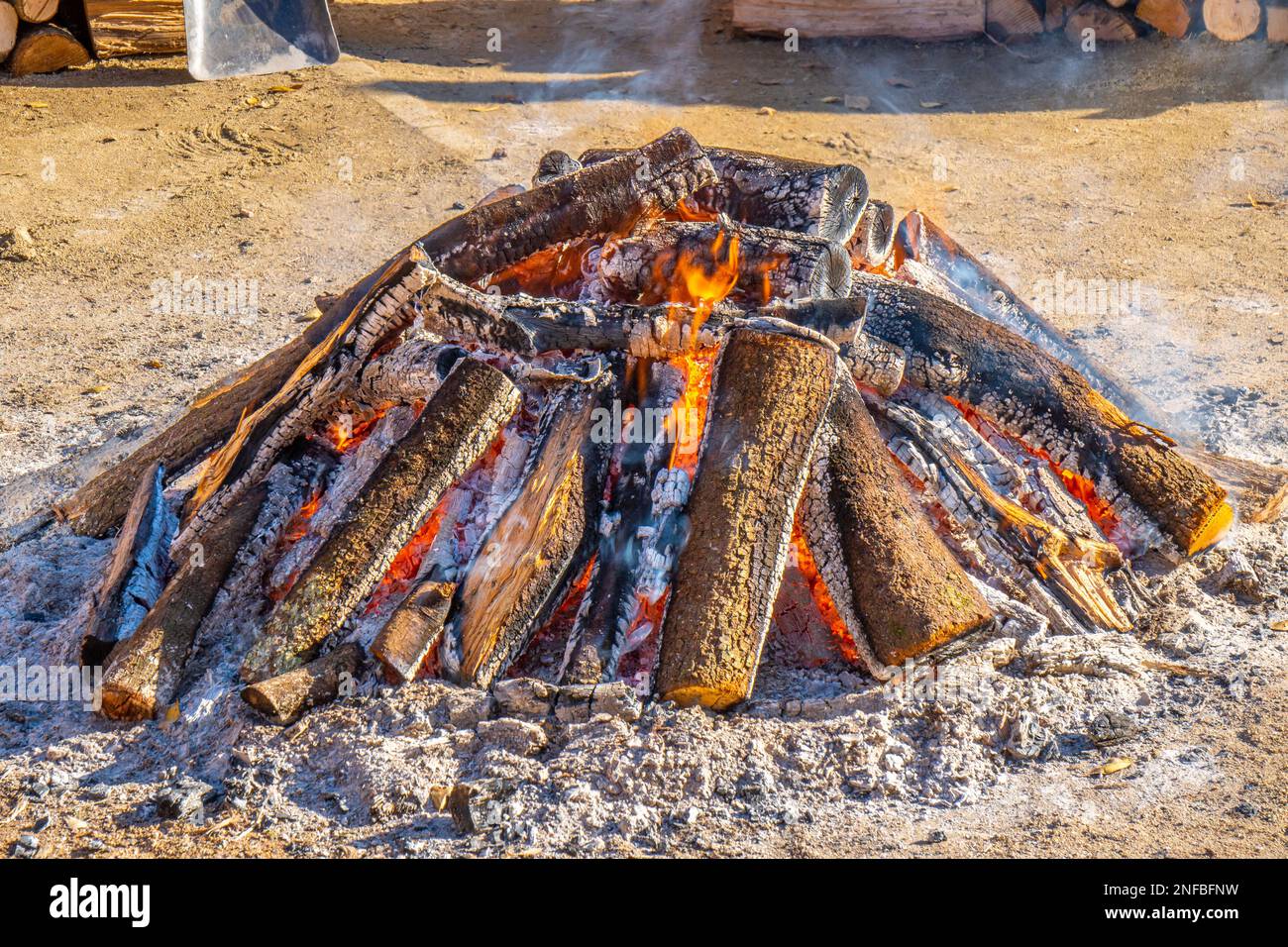 Top of a large circular bonfire packed with firewood on the sides that ...