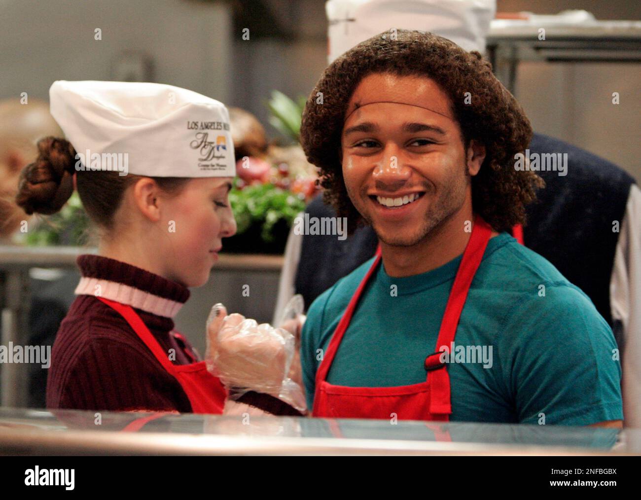 Actress Brittany Curran, left, and actor Corbin Bleu help serve the Los ...