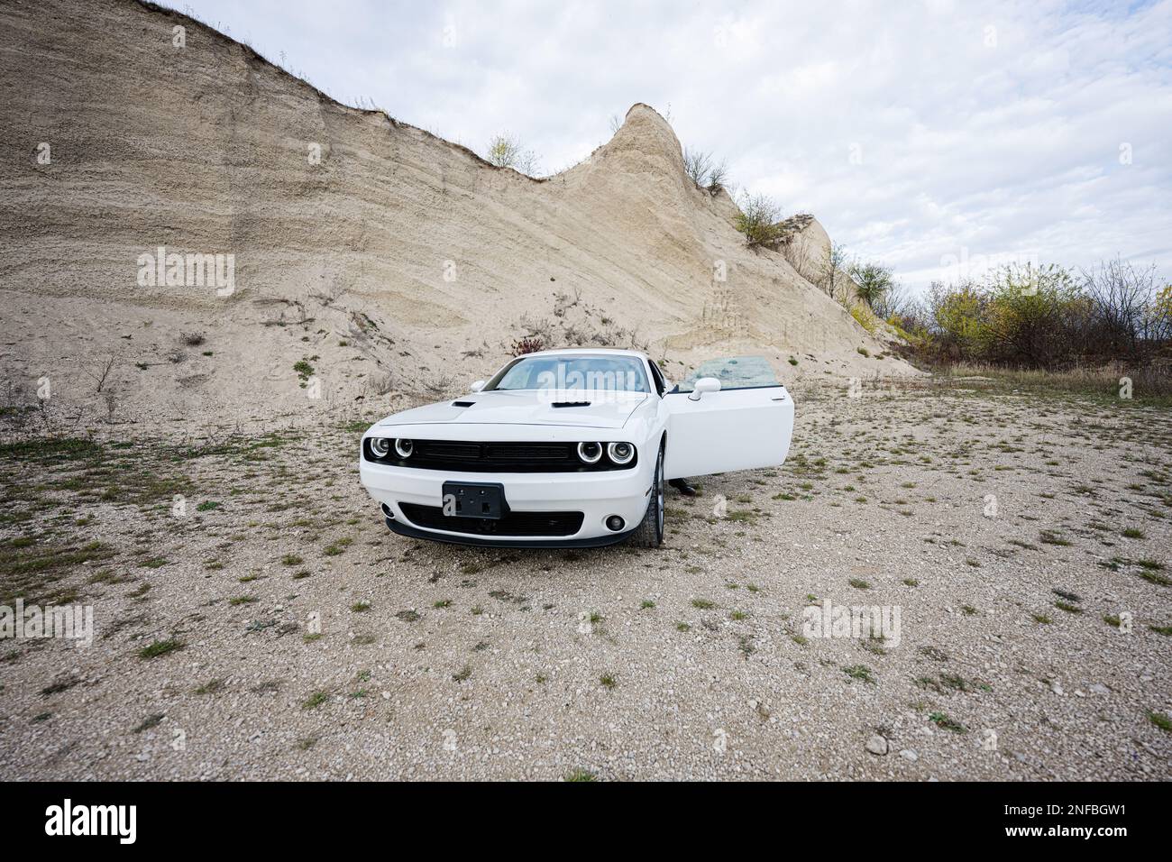 Handsome man sit in his white muscle car in career Stock Photo - Alamy