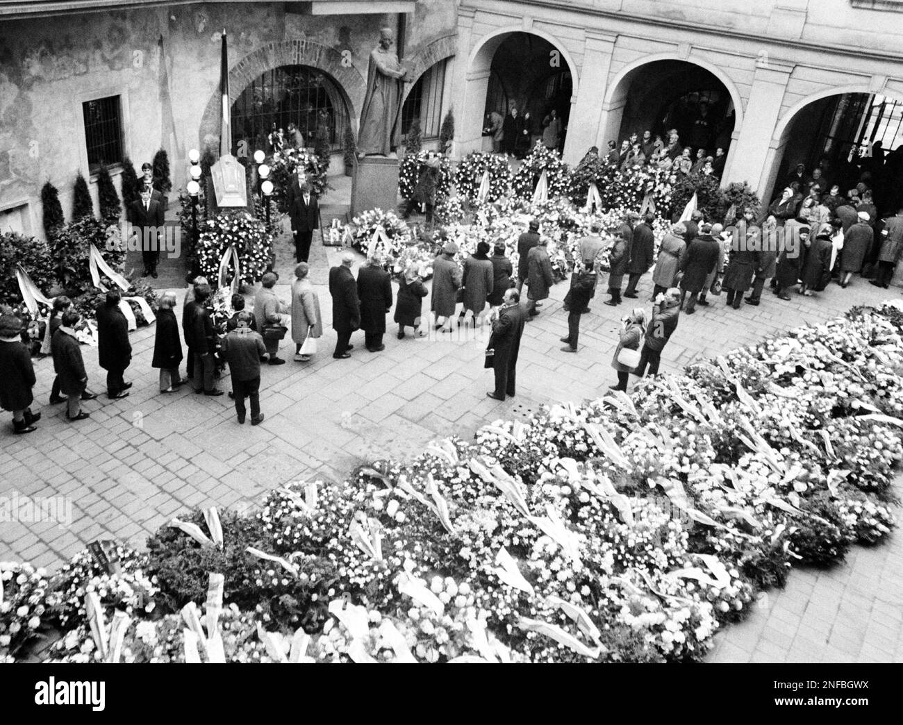 A sombre line of Czech mourners pass through the courtyard of the ...