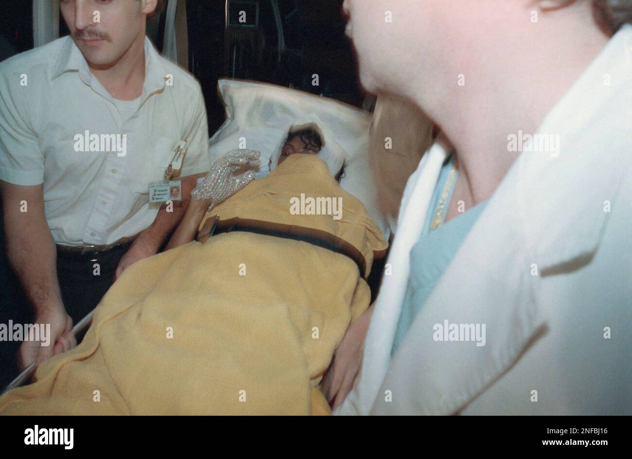 Singer Michael Jackson, center, is taken to an ambulance on stretcher ...