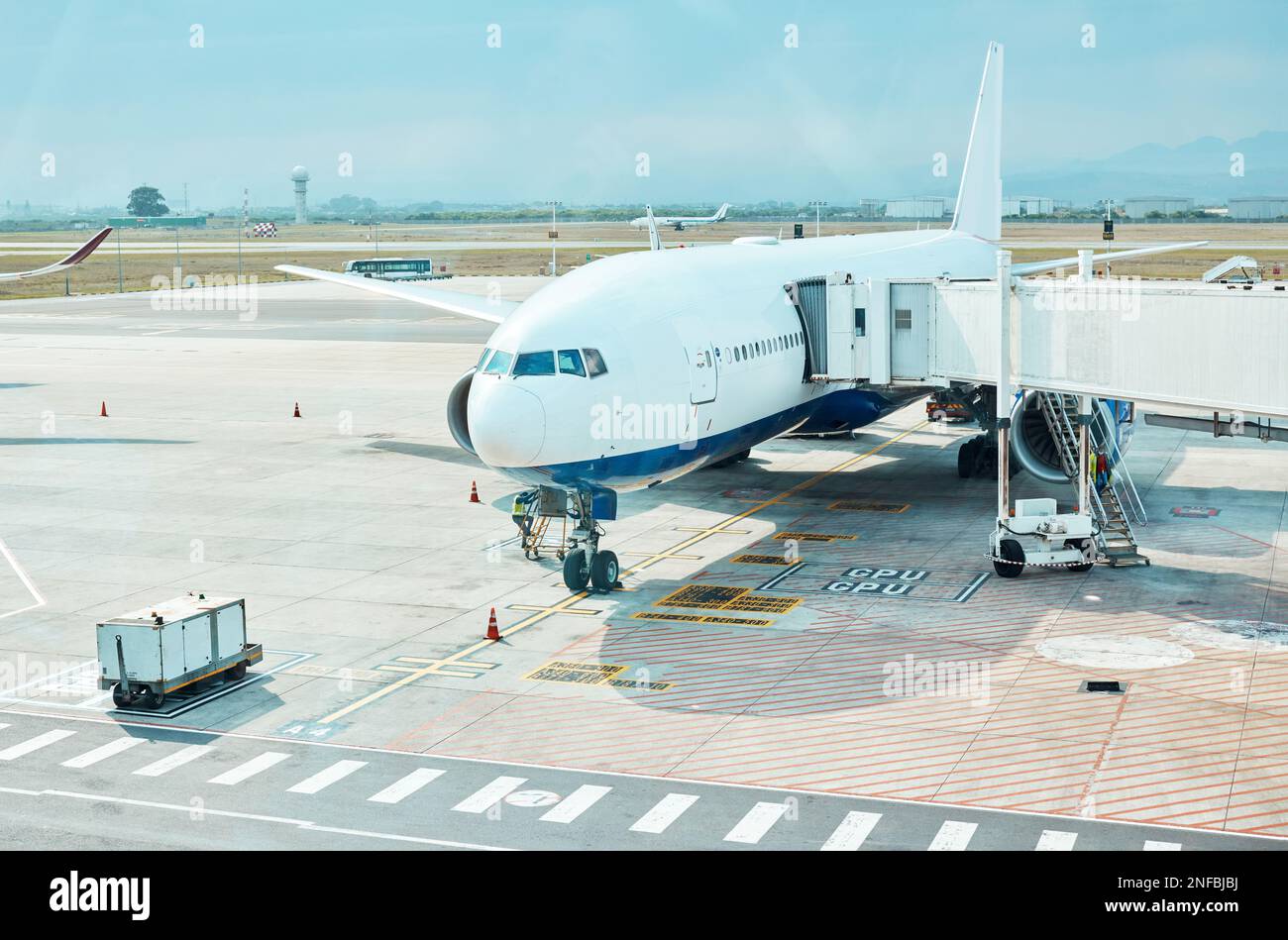 Airplane, airport and runway near terminal and boarding steps for a ...