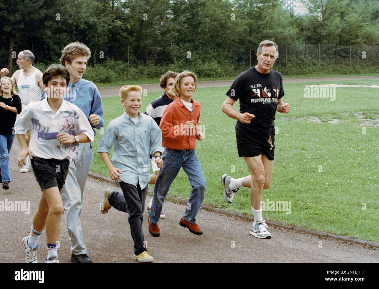 U.S. President George H. Bush takes a break from the official program ...