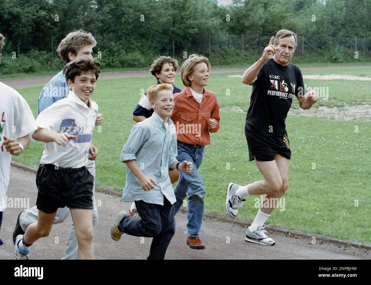 U.S. President George H. Bush takes a break from the official program ...