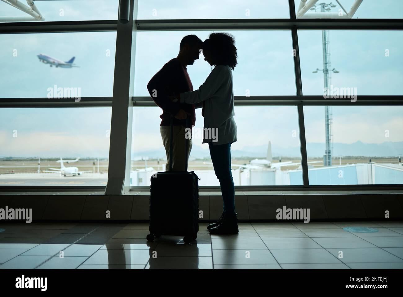 Airport, couple and silhouette of love, hug and leaving on vacation on ...