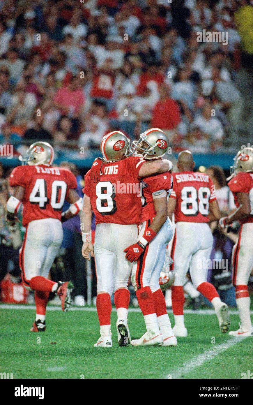 San Francisco 49ers quarterback Steve Young, left, hugs teammate Jerry ...