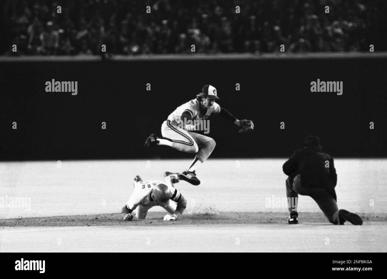 Milwaukee Brewers shortstop Robin Yount hops over St. Louis Cardinals ...