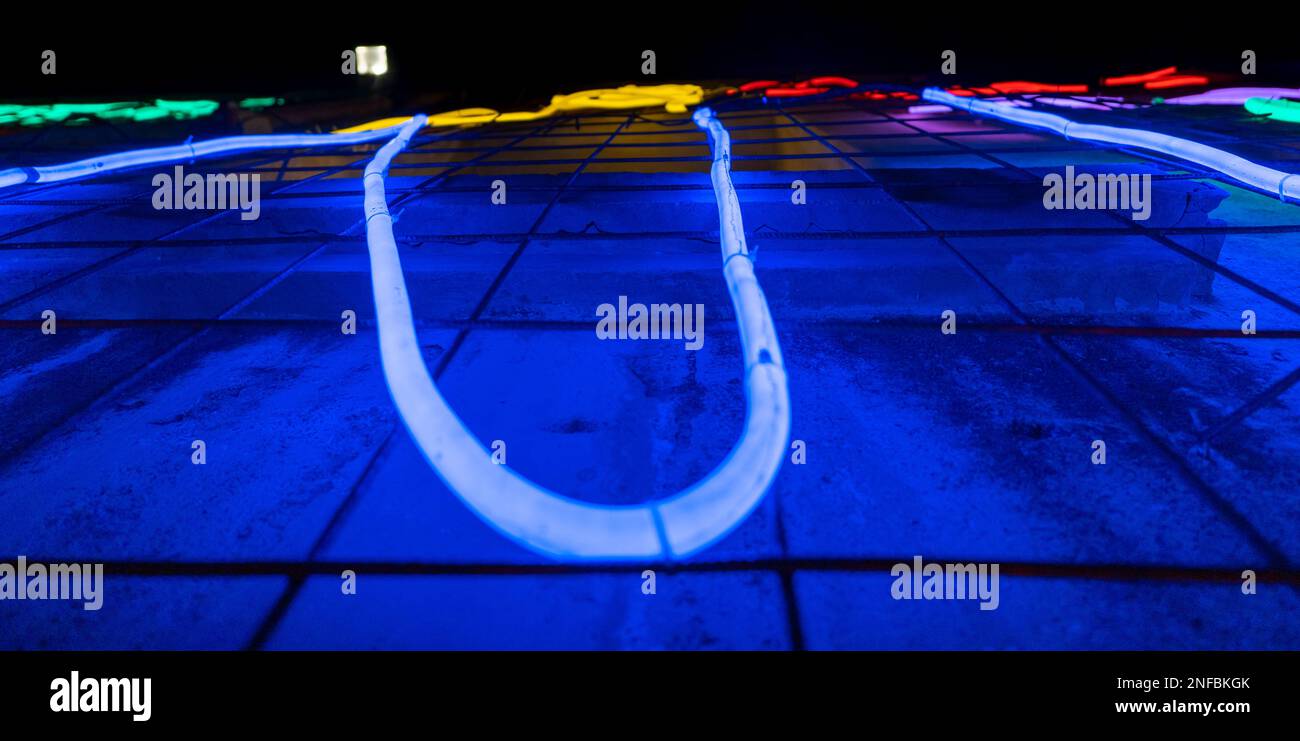 Illuminated letters and words made with neon lights and blue LEDs of ...