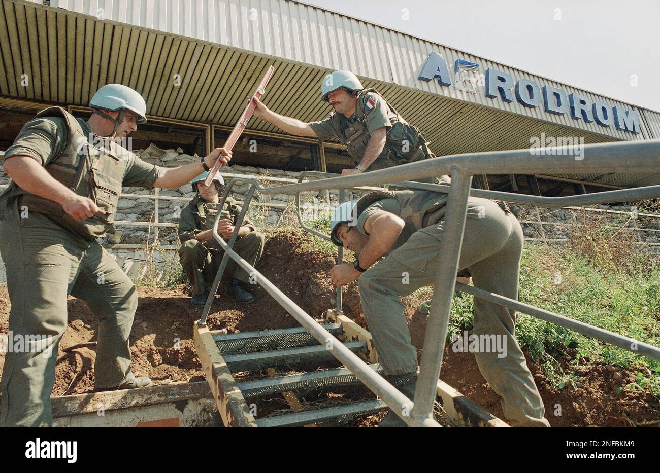 French UN soldiers work at Sarajevo airport repairing damage caused ...