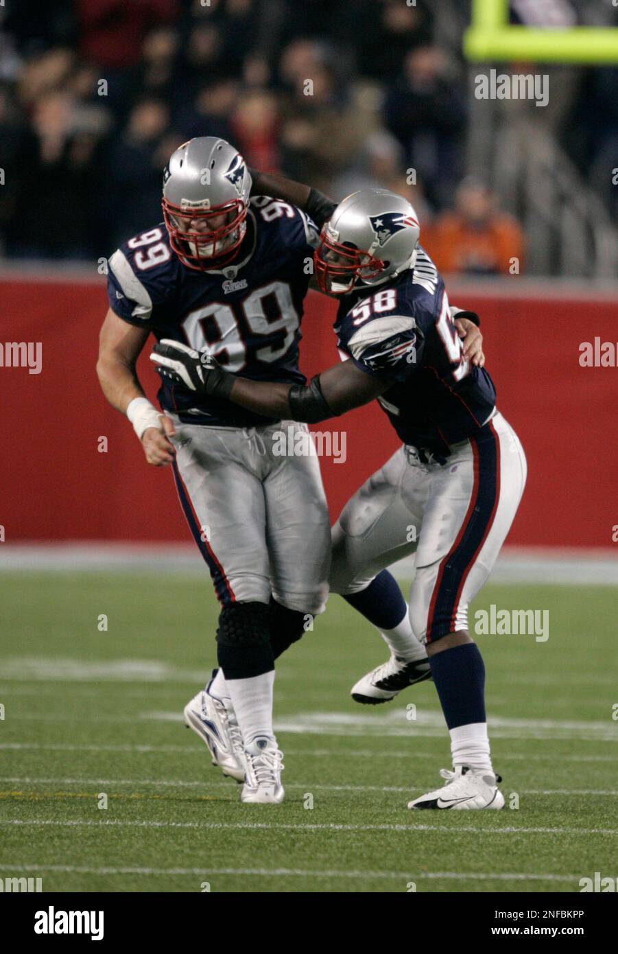 New England Patriots' Mike Wright (99) and Pierre Woods (58) celebrate ...