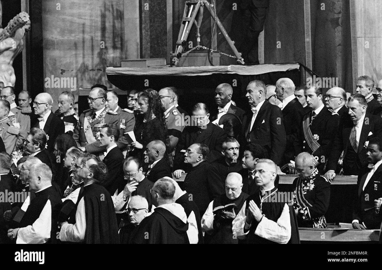 Representatives of the United States are shown with other envoys during ...