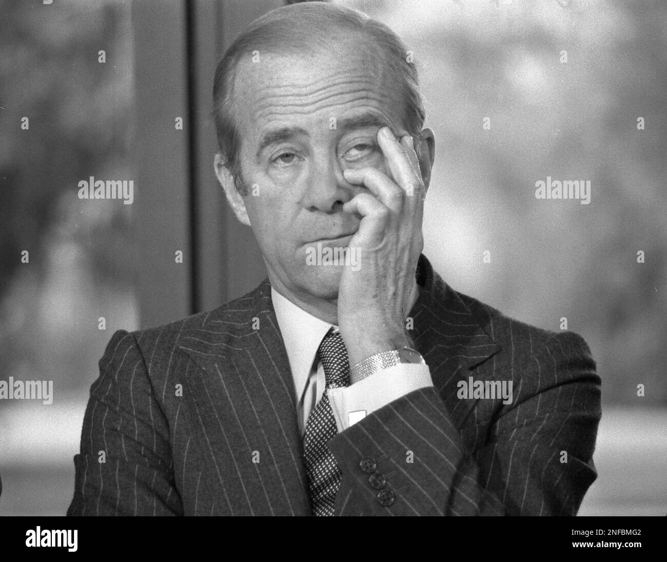 French foreign minister Jean Francois Poncet, pulls down an eyelid, holding his face with one ...