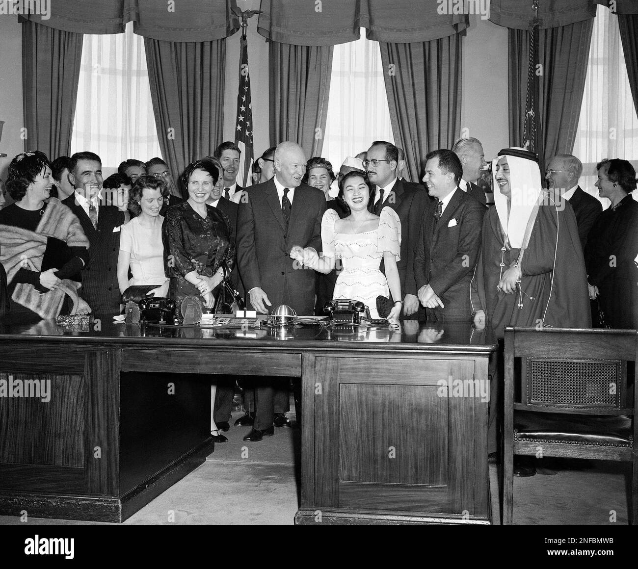 President Dwight Eisenhower holds onto the arm of Mrs. Ramon A. Hermano ...