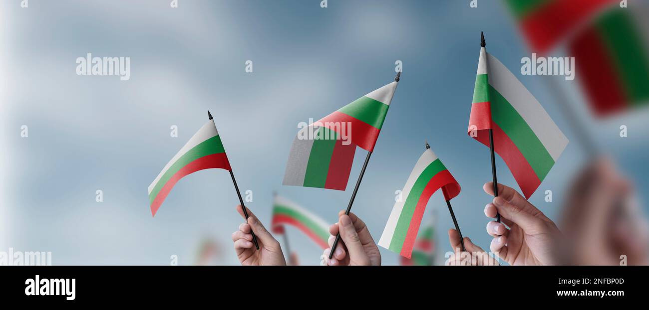 A group of people holding small flags of the Bulgaria in their hands ...