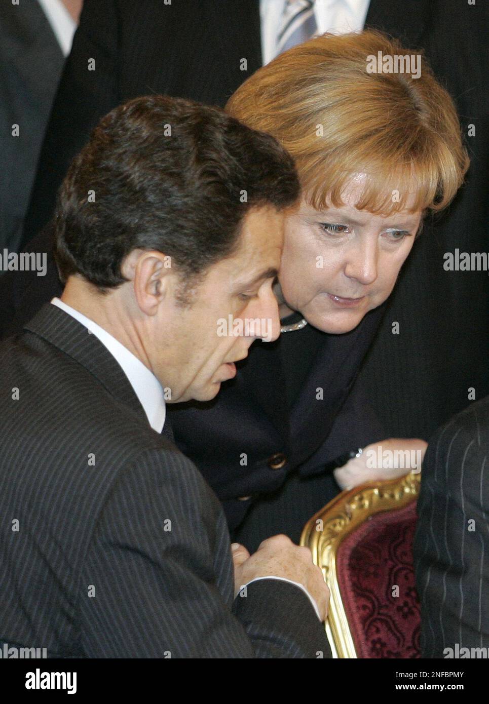 French President Nicolas Sarkozy, left, and German Chancellor Angea ...
