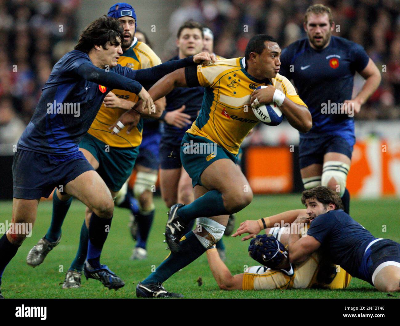 France's David Skrela, left, tries to stop Australia's Sekope Kepu ...