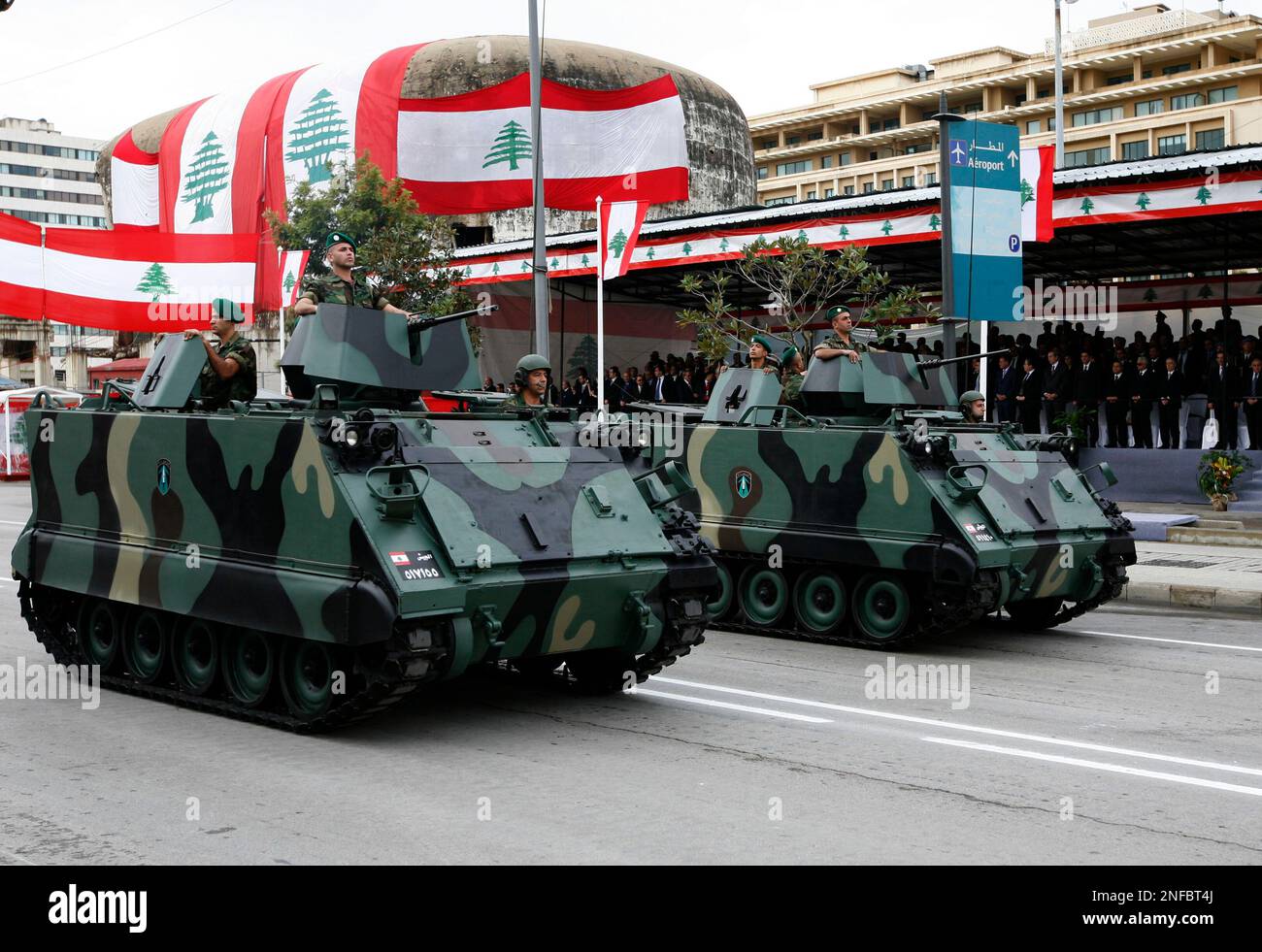 Lebanese soldiers, stand on the top of their armored personnel carrier ...