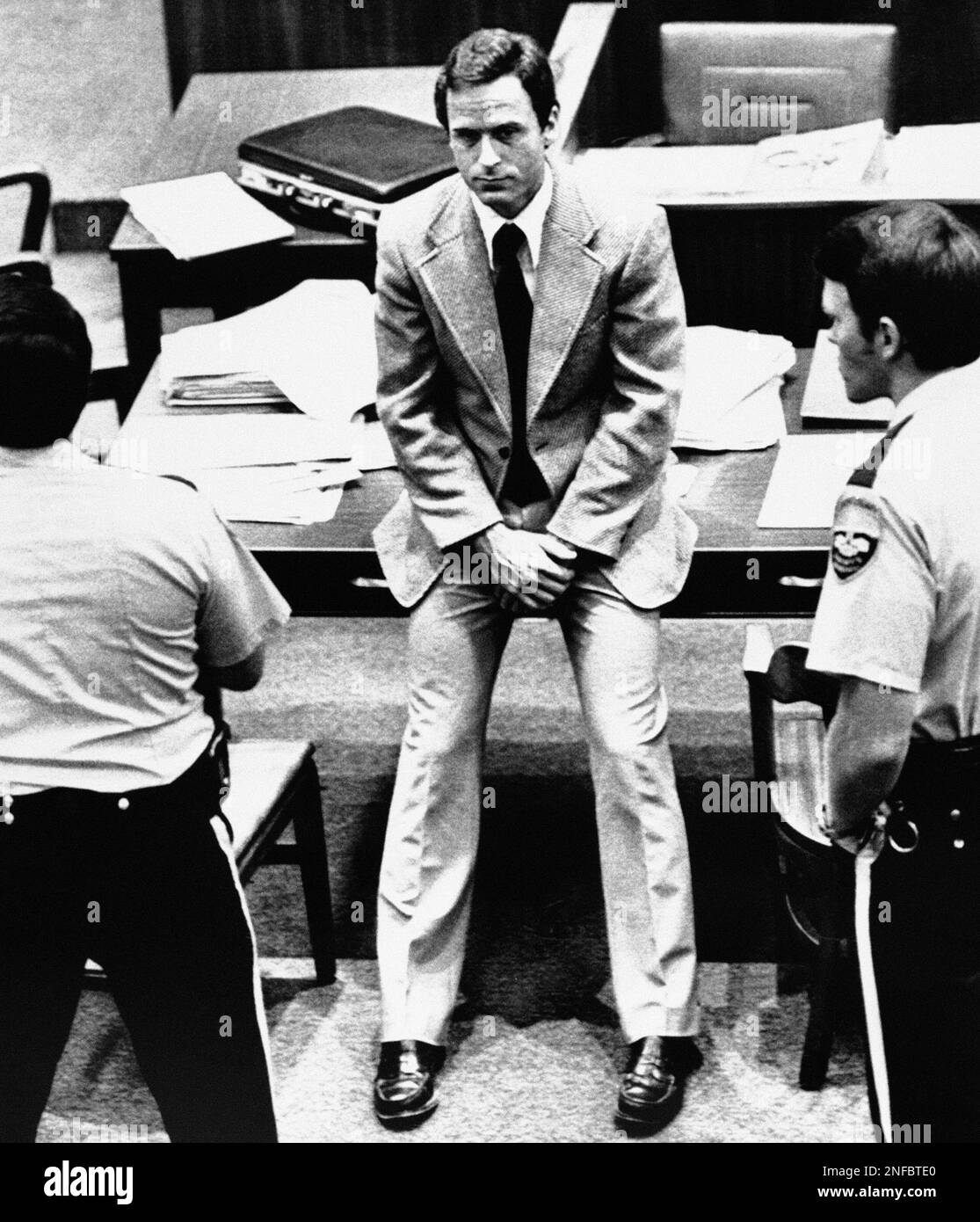 Theodore Bundy, center, is flanked by two unidentified sheriff's ...