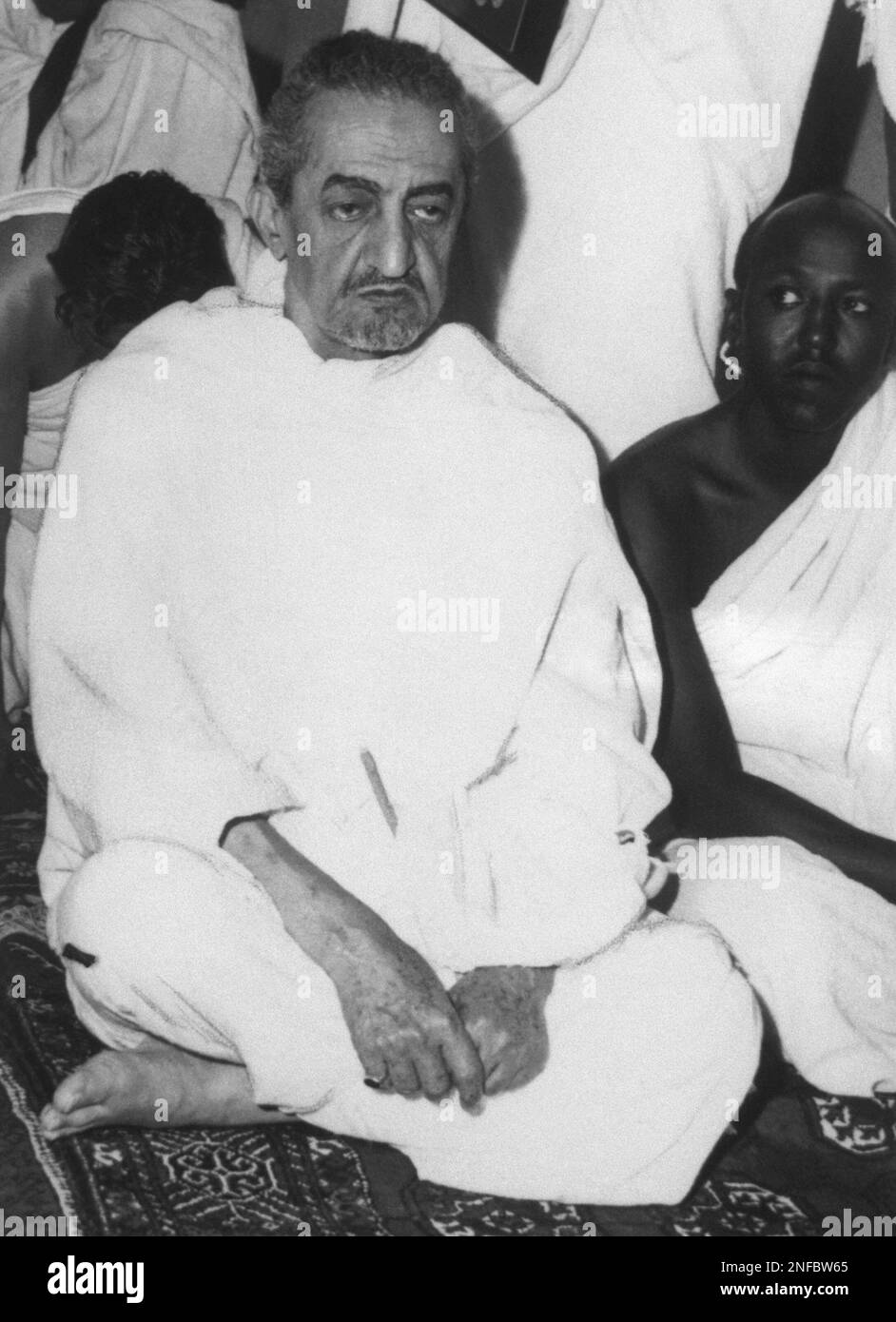 King Feisal of Saudi Arabia sits at Mecca on March 23, 1968, dressed in ...