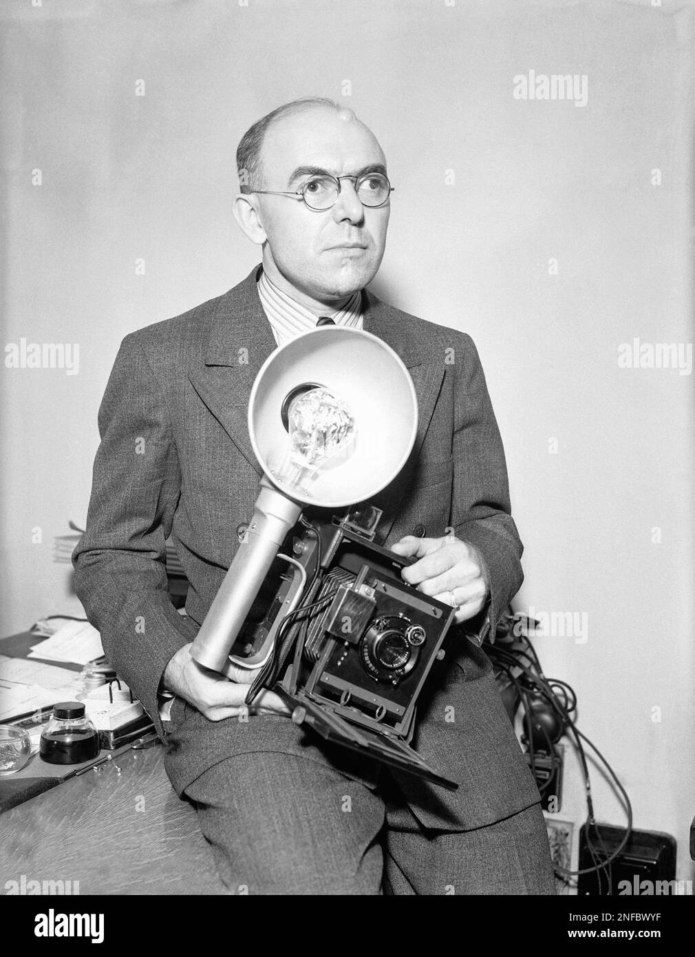 AP photographer Harry Biele is shown with his first production model of ...