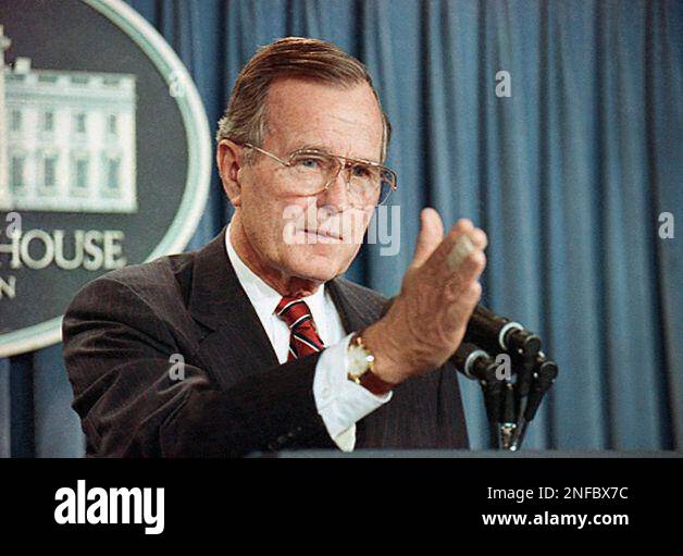 President George Bush gestures during his impromptu news conference at ...