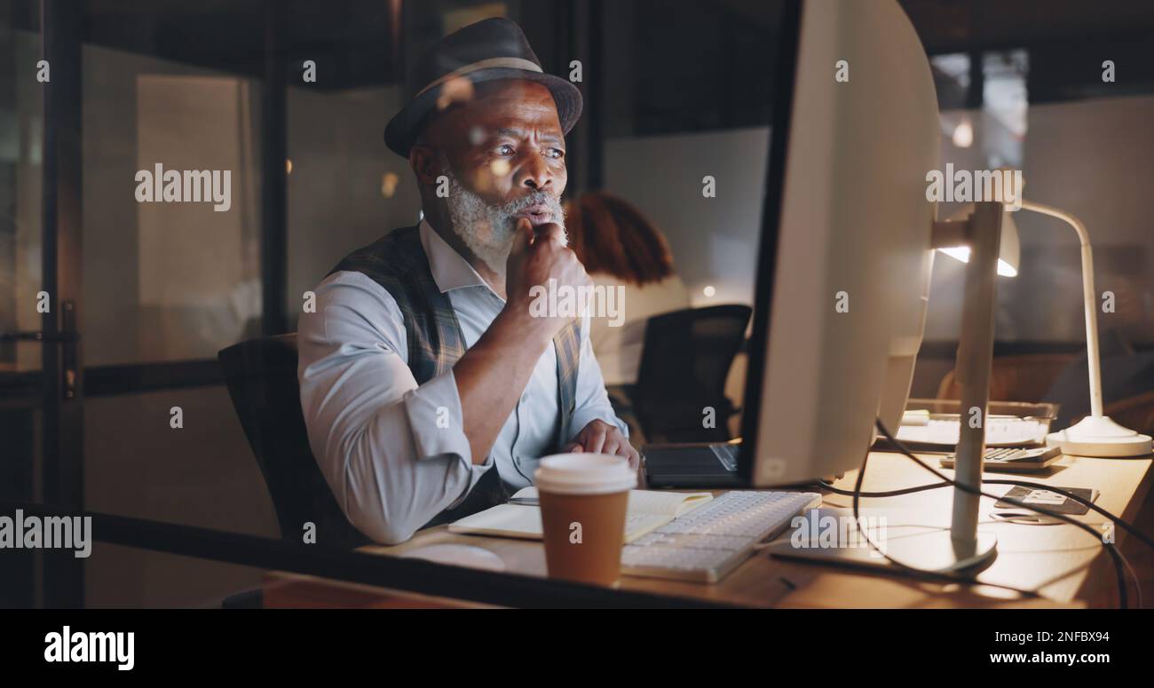 Businessman, focus and computer, typing and working overtime ...