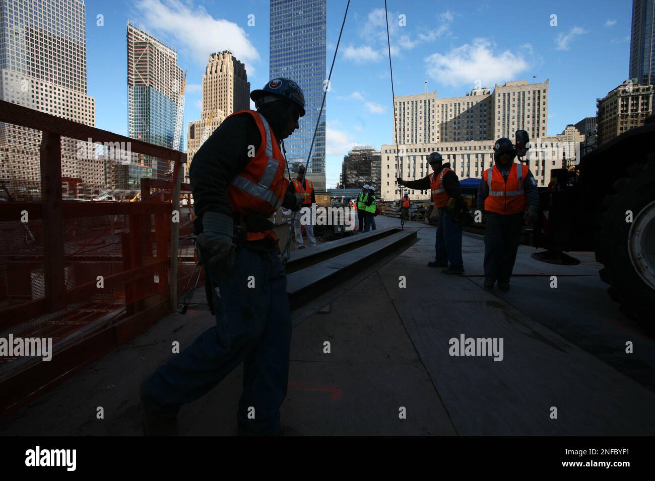 Construction workers manuever steel beams at the World Trade Center ...
