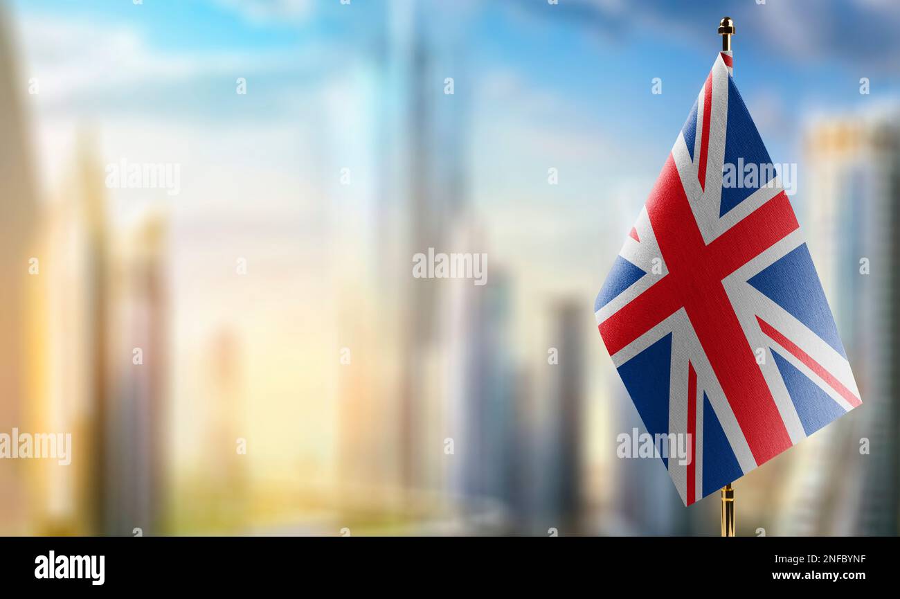 Small flags of the United Kingdom on an abstract blurry background ...