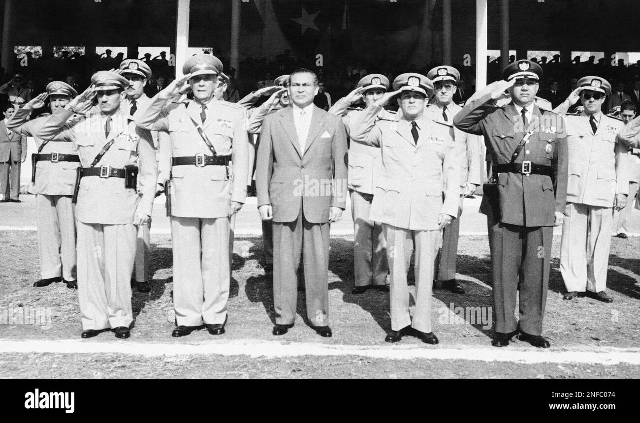 Cuban President Fulgencio Batista stands in review with his general ...