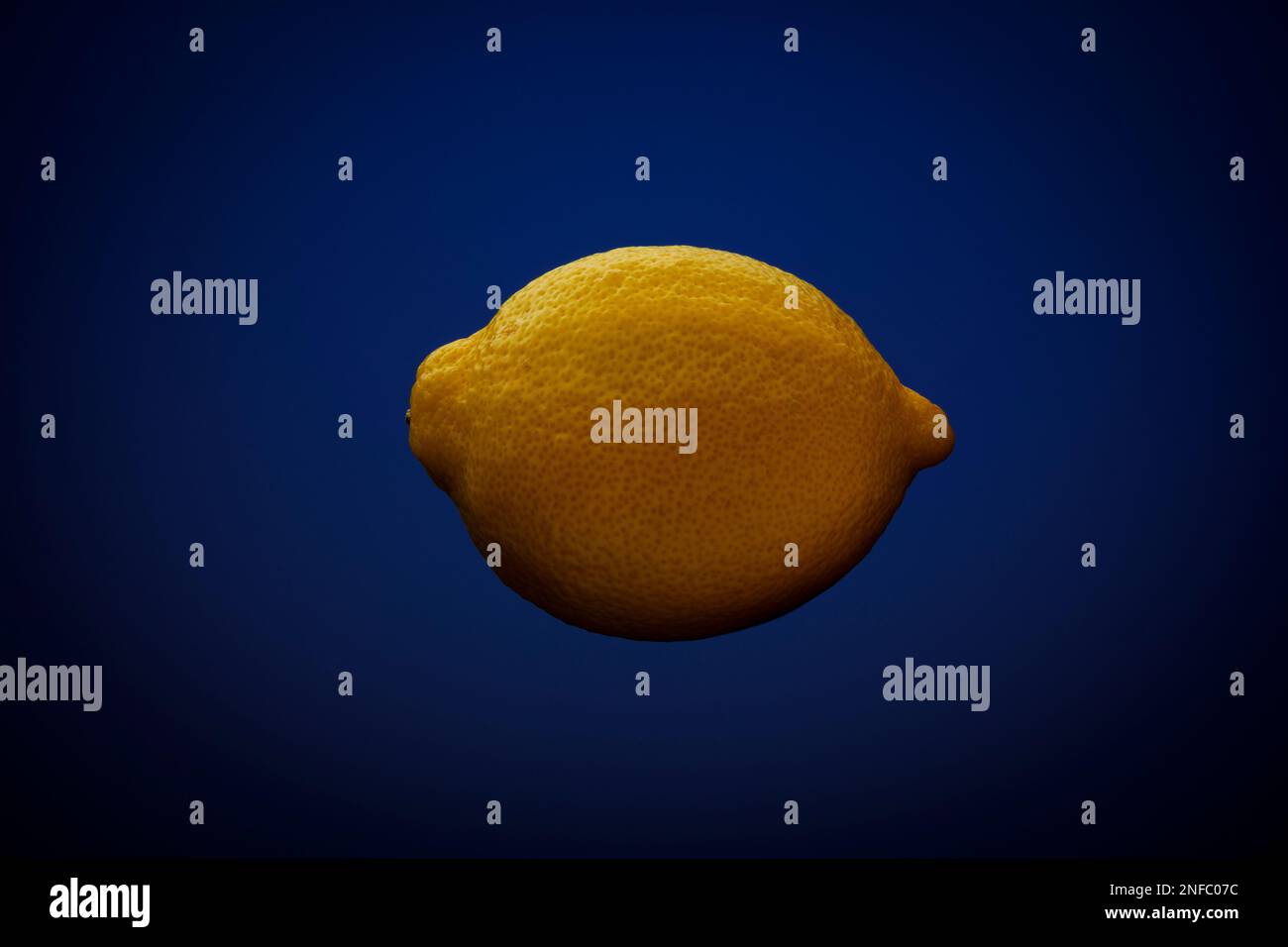 lemon floating on blue background Stock Photo - Alamy