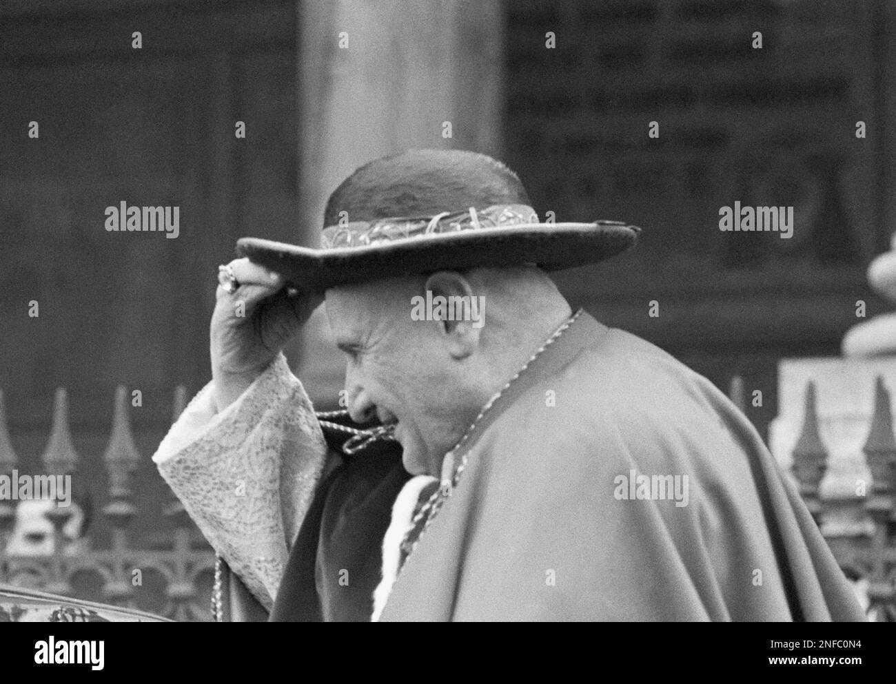 Pope John XXIII holds his hat against a strong wind, as he leaves the ...