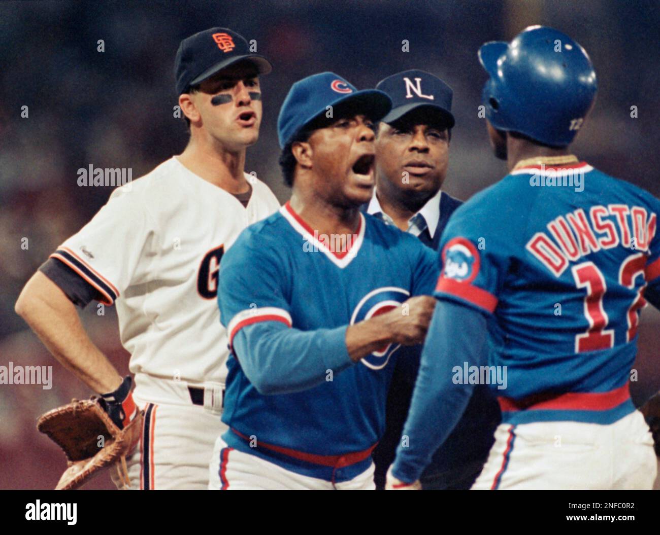 Chicago Cubs first base coach Jose Martinez, center, and first base ...