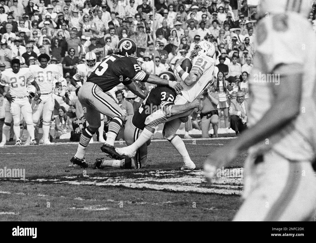 Miami Dolphins' Jim Kiick (21) is tackled by Washington Redskins' Jack ...