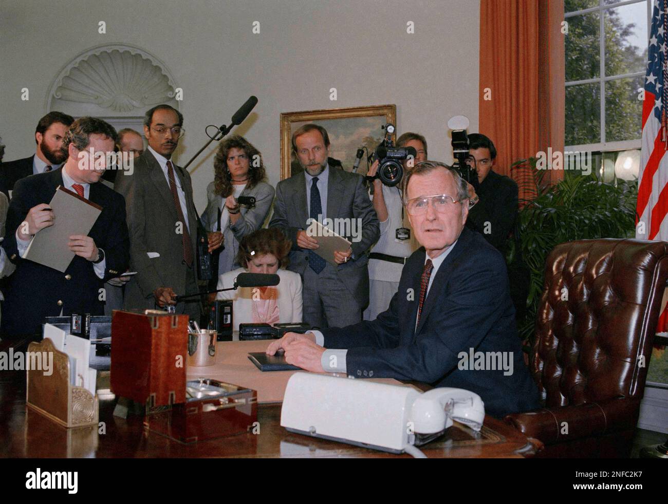 U.S. President George H. Bush talks to reporters during a news ...