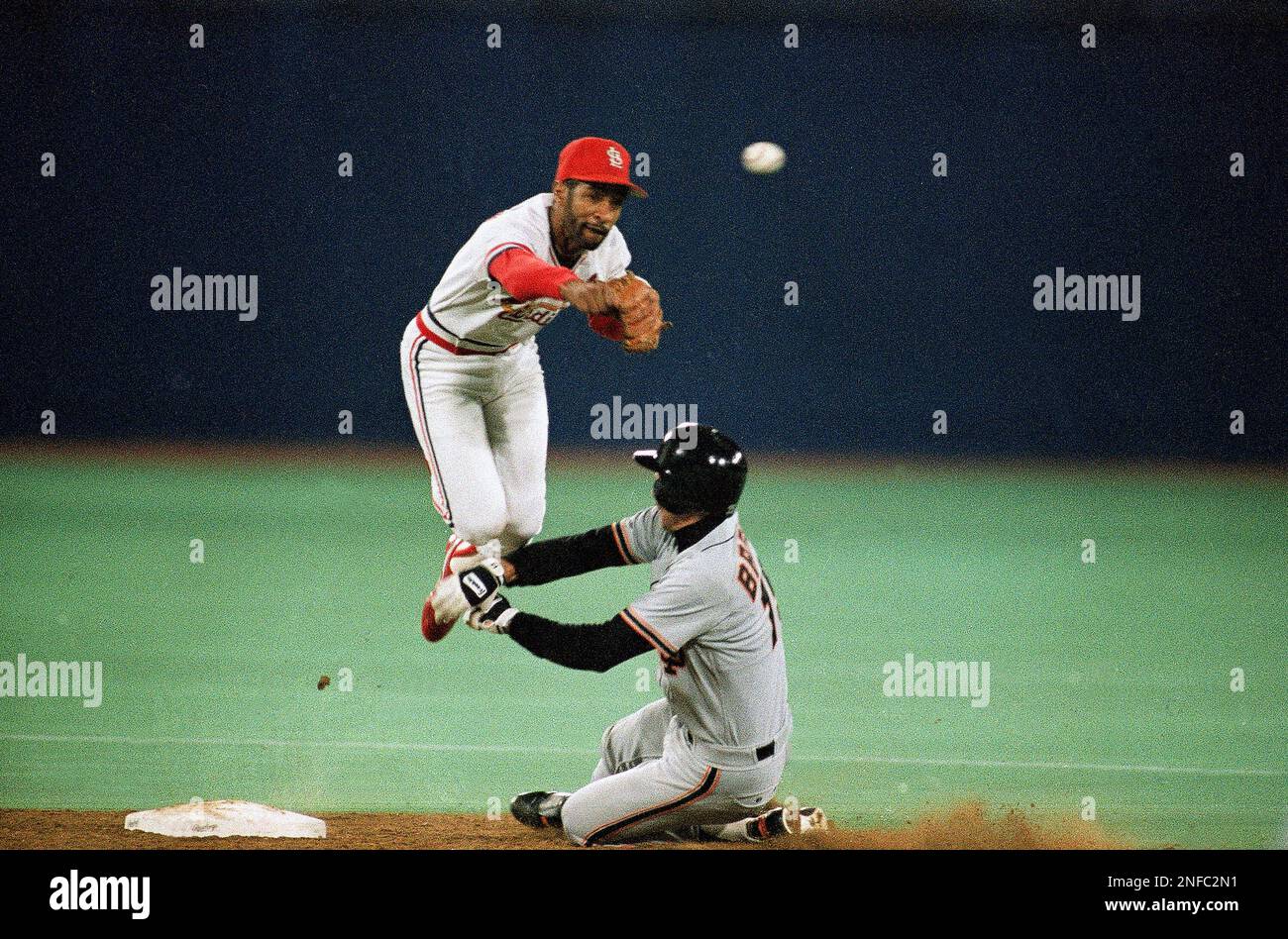 St. Louis Cardinals Ozzie Smith turns a fifth inning double play on a ...