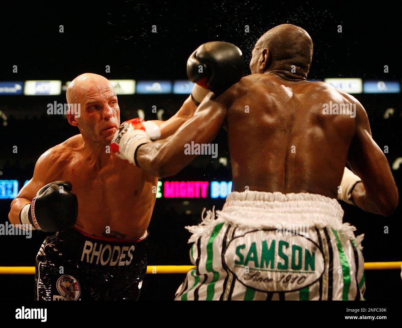 British middleweight Ryan Rhodes, left, punches from South African ...