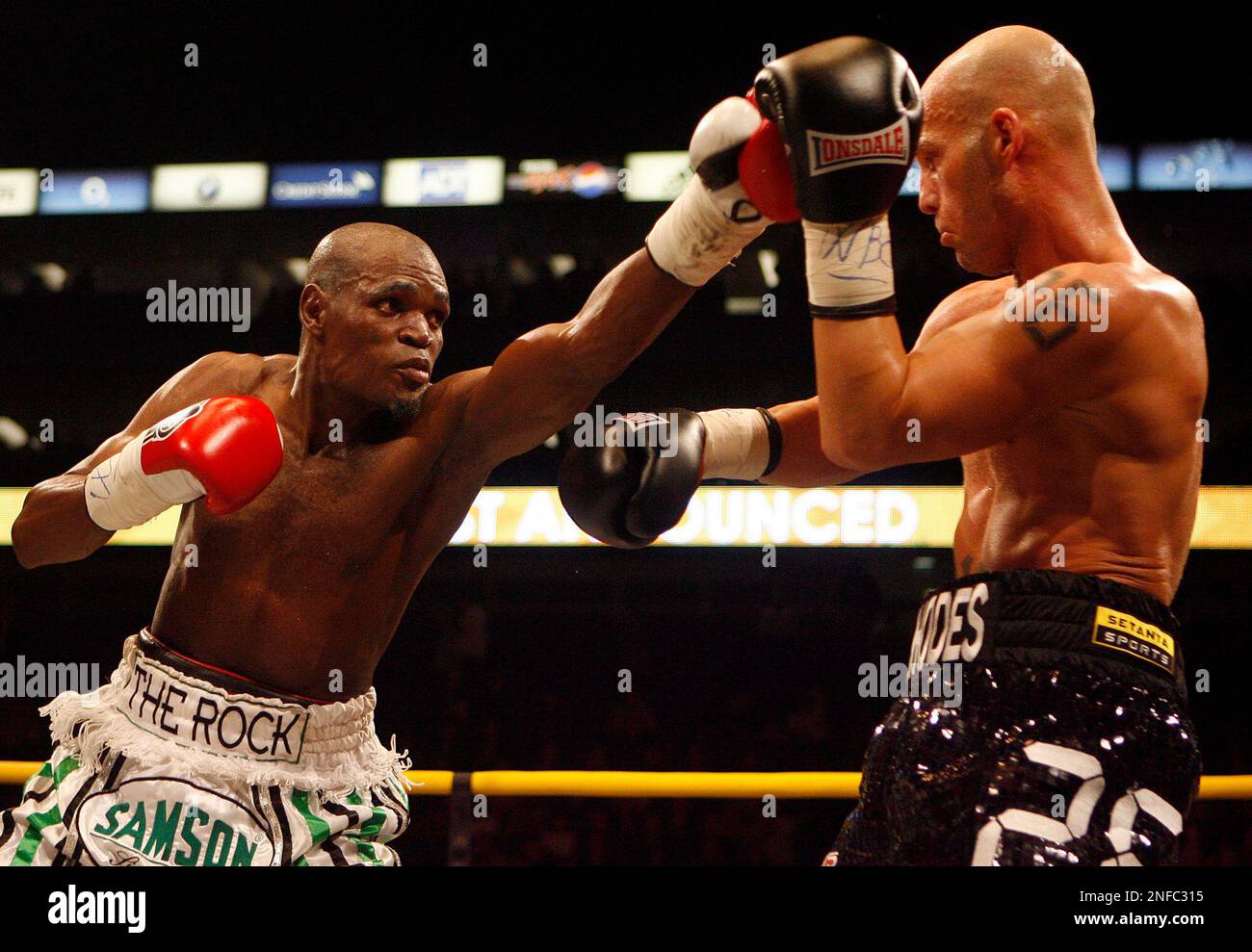British middleweight Ryan Rhodes, right, is hit by a punch from South ...