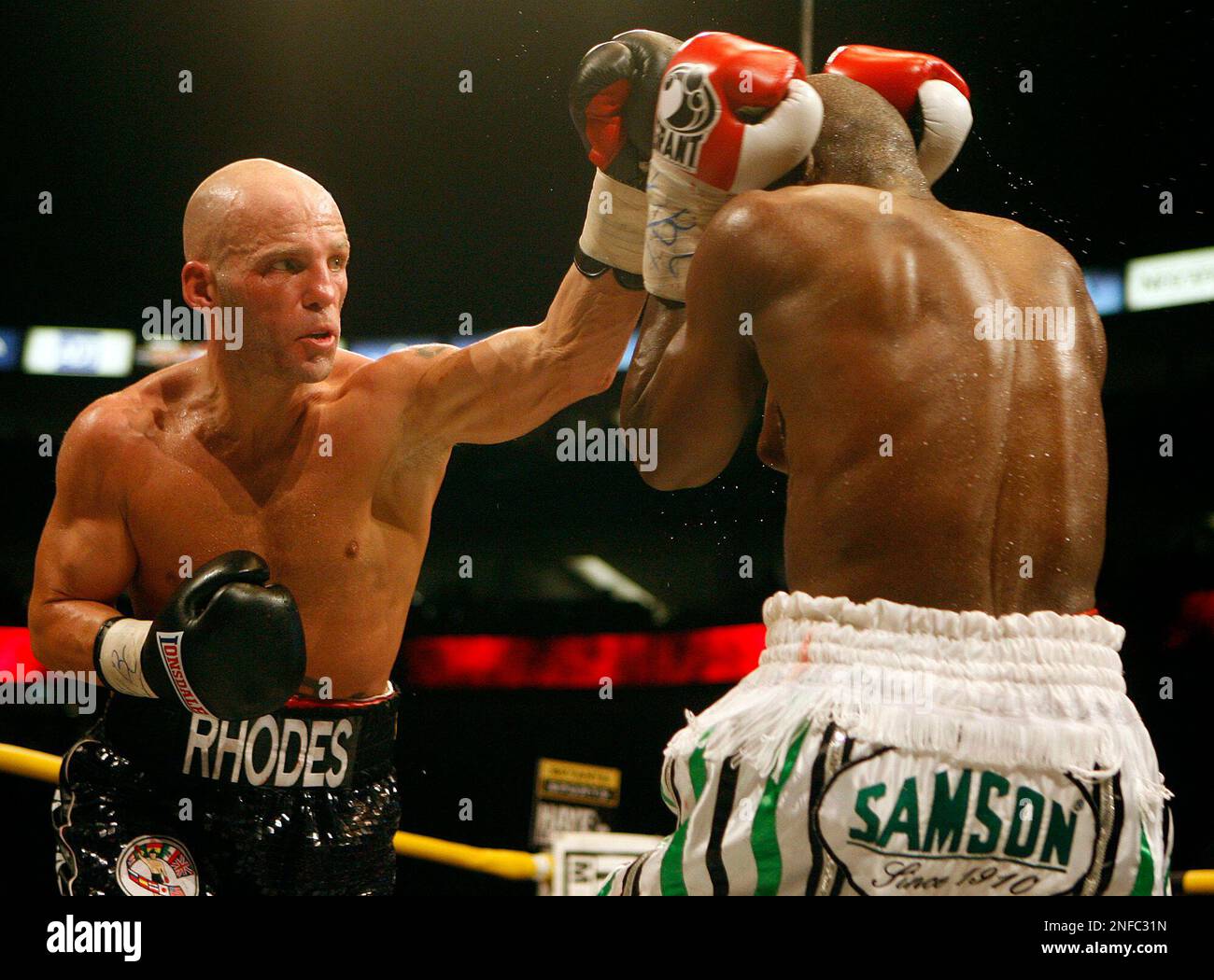 British middleweight Ryan Rhodes, right, punches South African Vincent ...