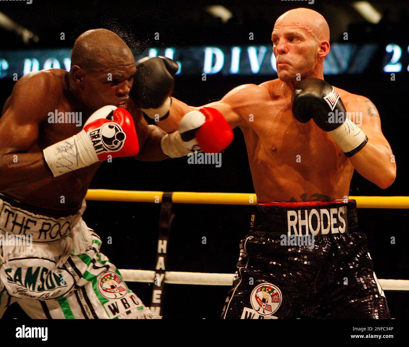 British middleweight Ryan Rhodes, right, punches South African Vincent ...