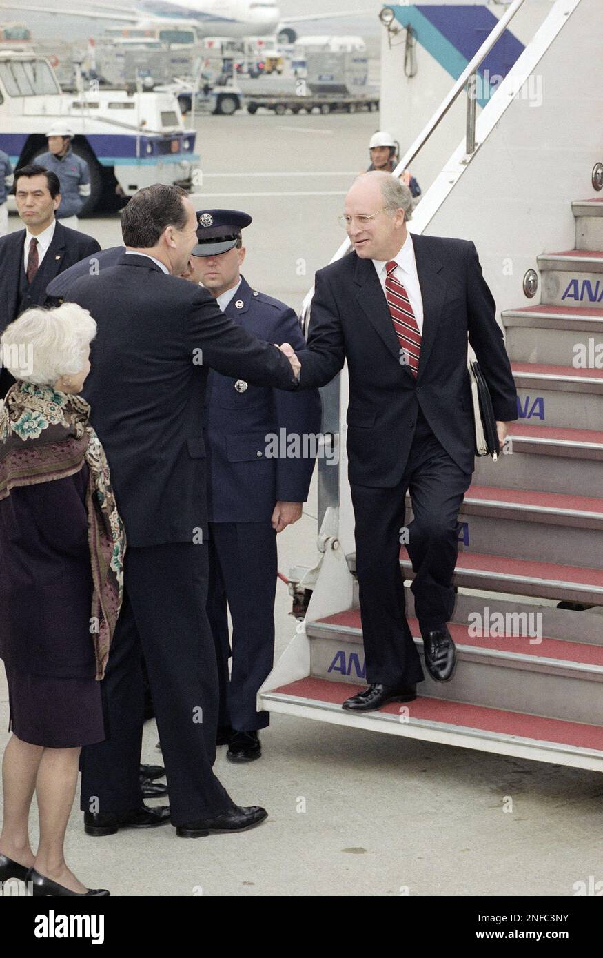 Defense Secretary Dick Cheney is greeted by Ambassador Michael Armacost ...