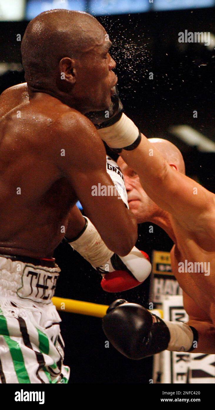 British middleweight Ryan Rhodes, right, punches South African Vincent ...